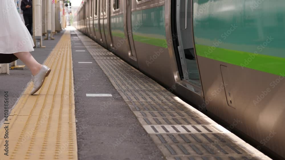 Passenger woman walk out from Japanese rapid transit train. Low half ...