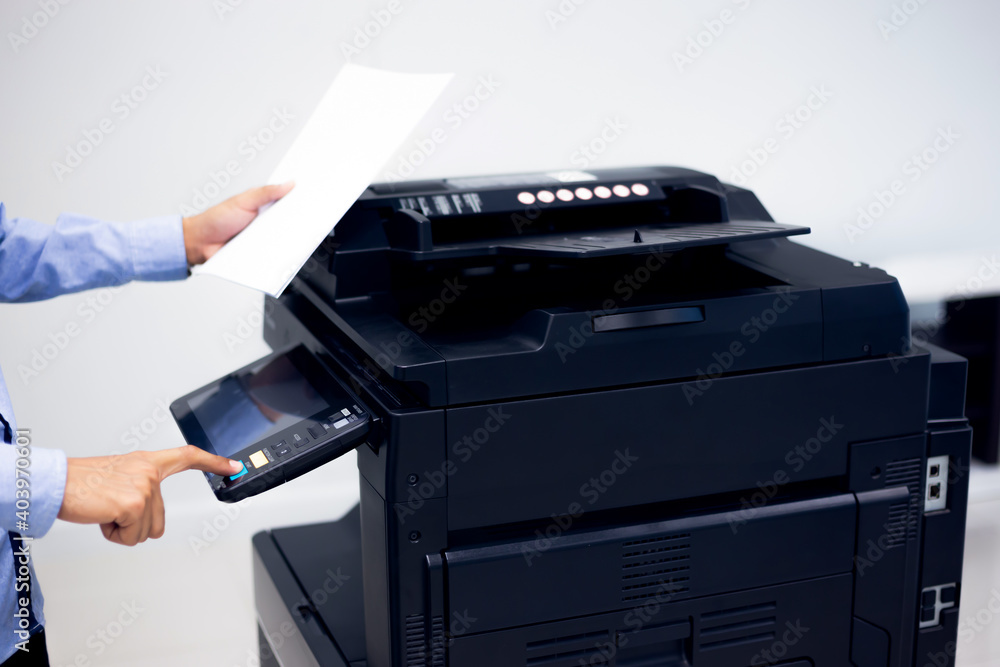 Bussiness man Hand press button on panel of printer, printer scanner ...