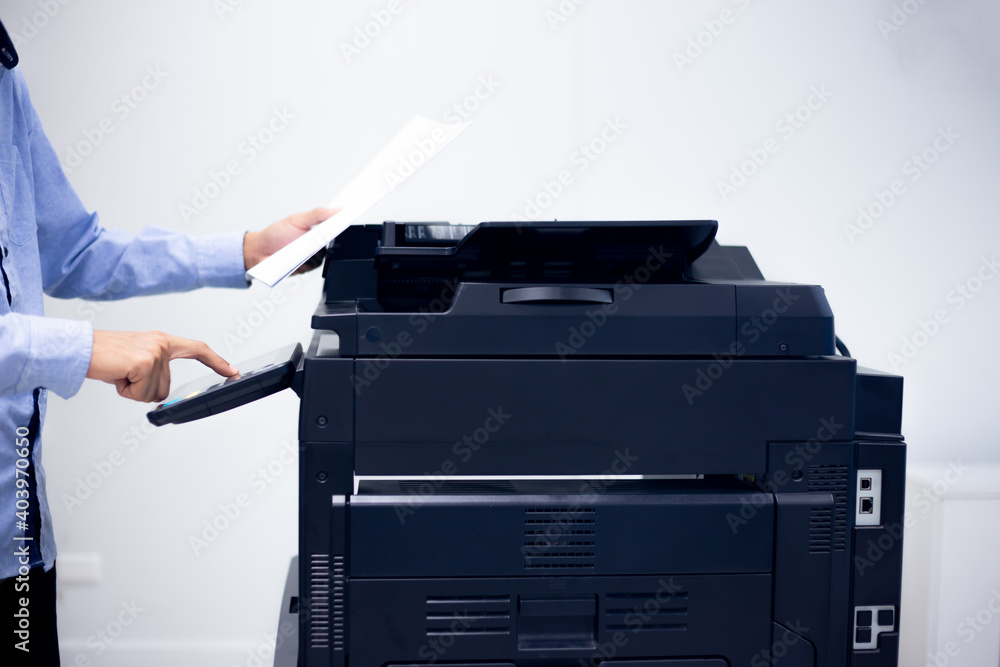 Bussiness man Hand press button on panel of printer, printer scanner ...