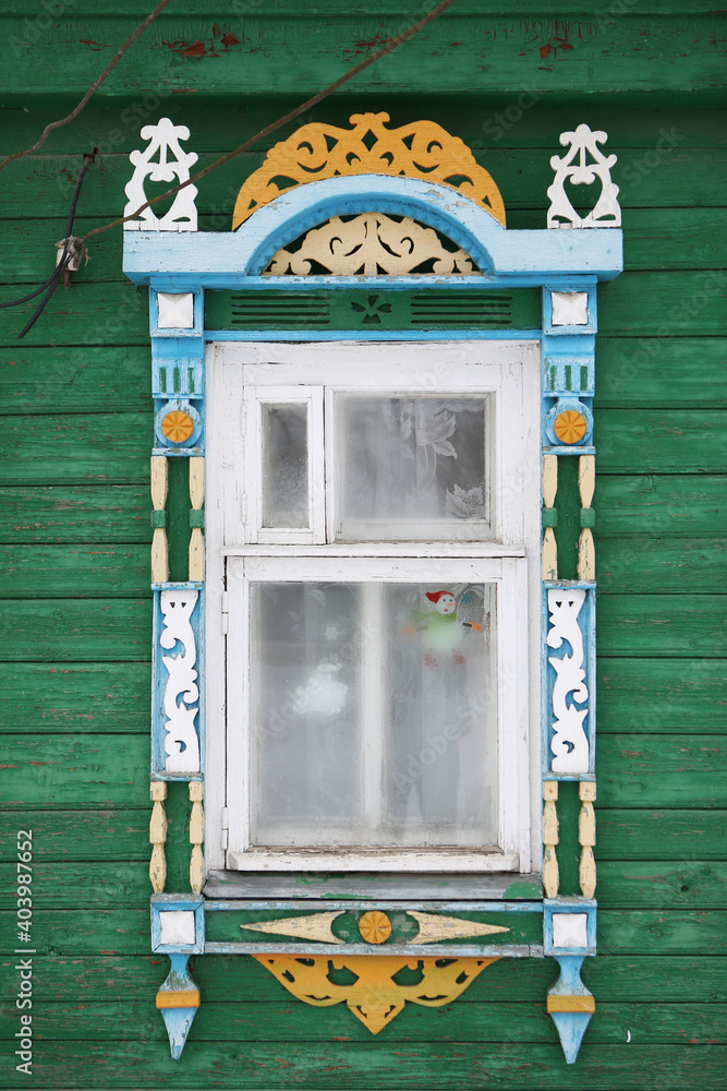 Ornamental window with carved frame on vintage wooden rural house in ...