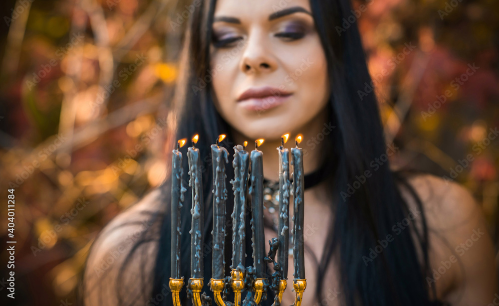 Portrait of mysterious lady with a candle, magic and rituals concept ...