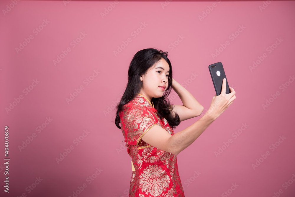 Action portrait beautiful Asian girl wearing Cheongsam red dress. the ...