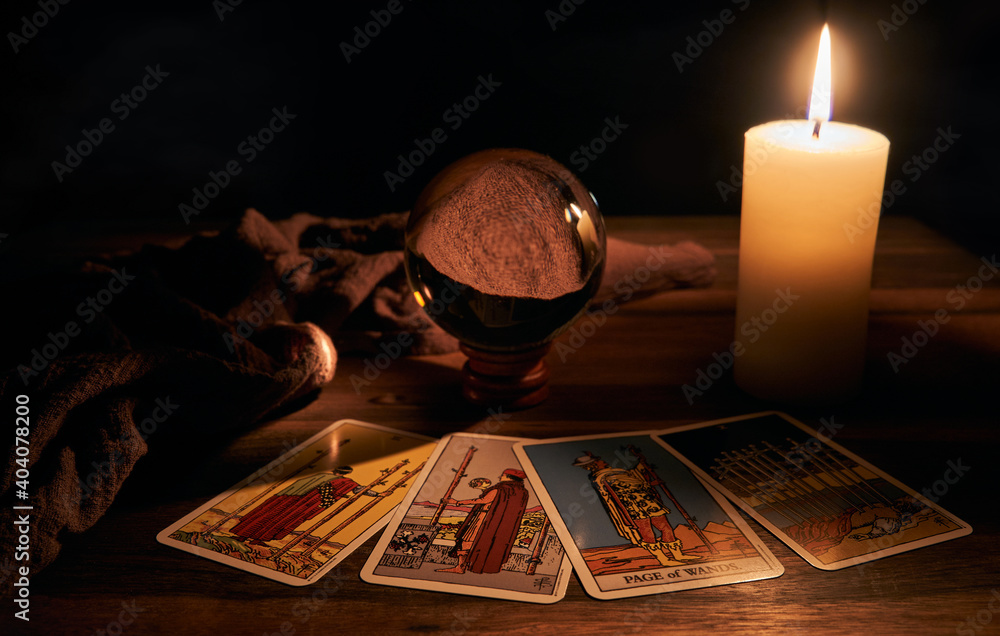 concept of fortune-telling wooden table and white candle with a crystal ...