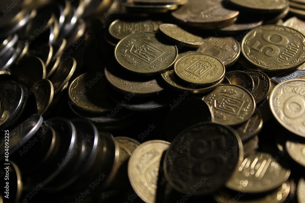 dusty hryvnia coins of different denominations in an oblique ray of ...