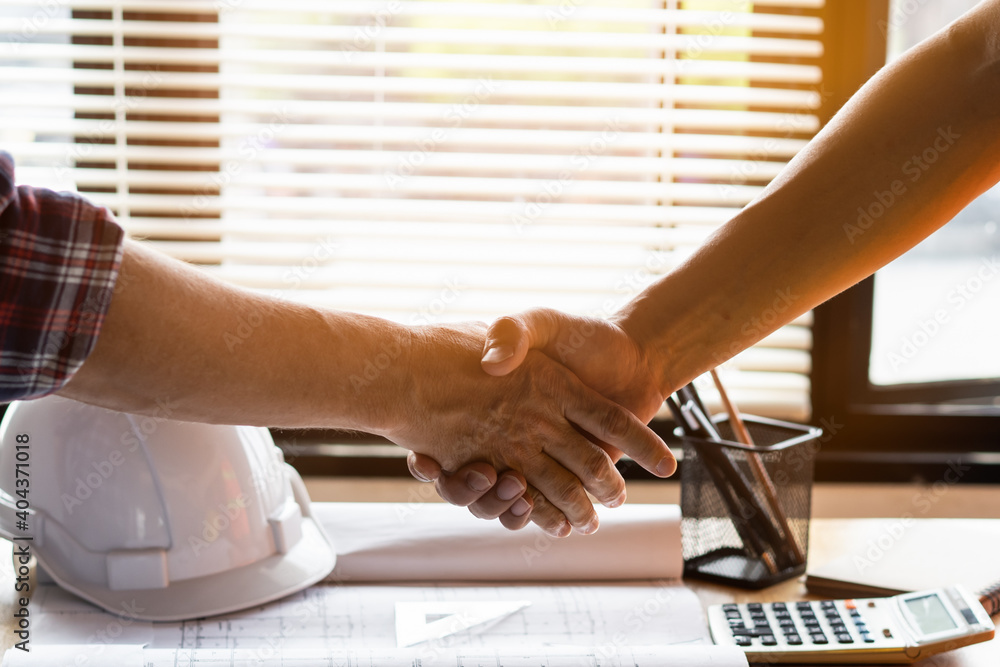 Successful deal, male architect shaking hands with client in ...