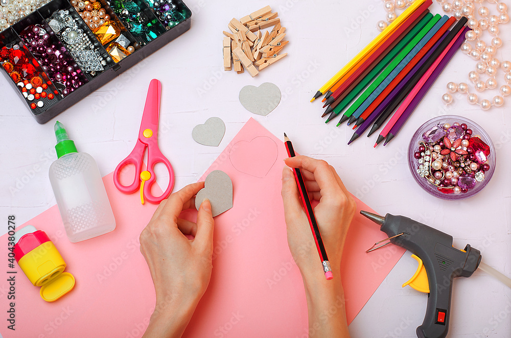 Step 3.Women's hands do the craft.On a light background, colored ...