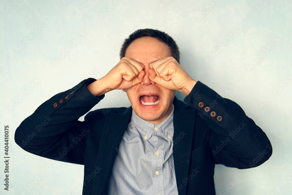 Portrait of a young businessman crying. man cries like a child. guy in ...