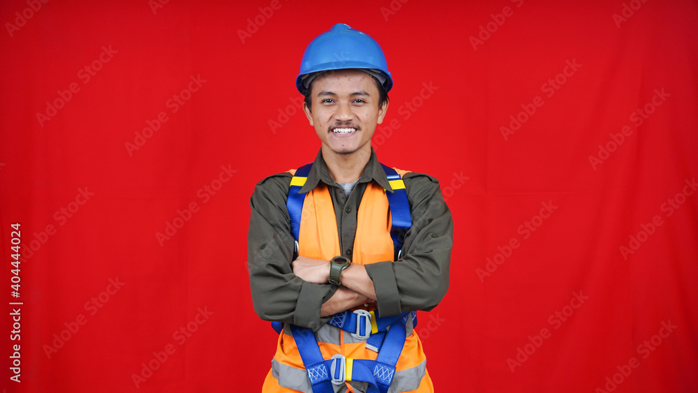 Asian worker man wearing uniform, helmet, safety harness isolated red ...