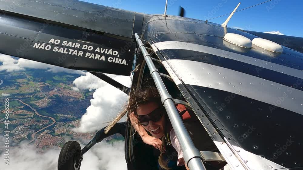 Video of a woman parachutist, at the door of the plane smiling ...