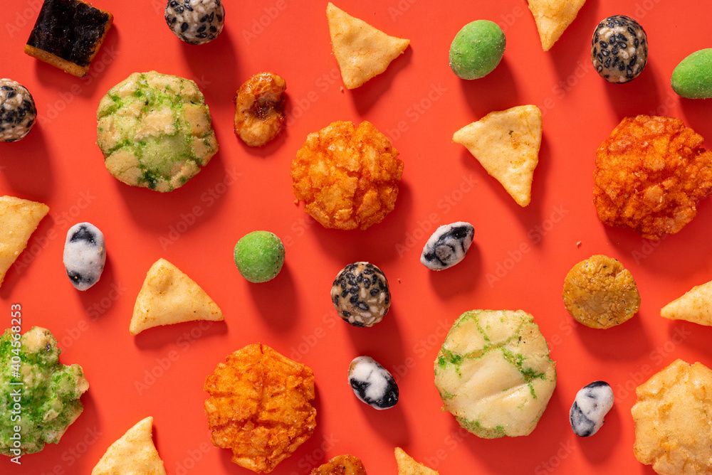 Pattern from various Japanese snacks on a red background. Top view ...