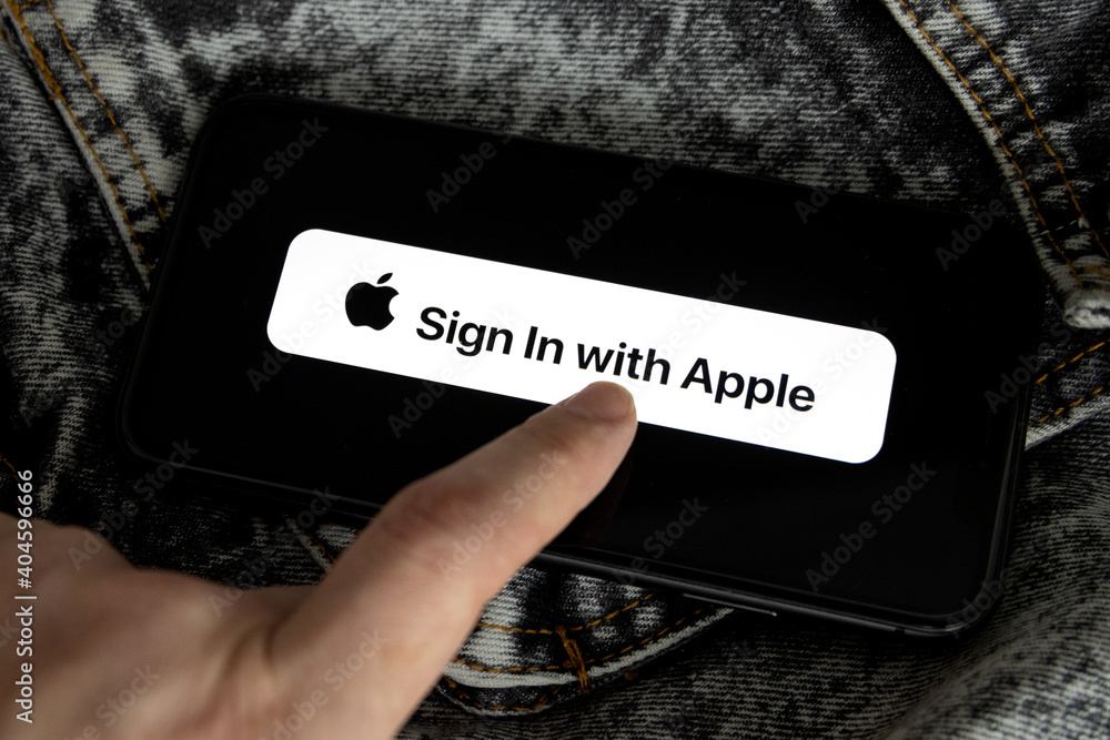 Apple ID logo on iPhone 11 screen with black and white denim background ...