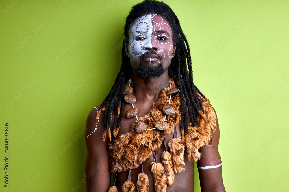shirtless african man with shaman aborigen make-up confidently looking ...