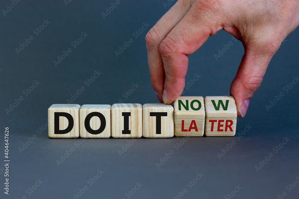 Do it now symbol. Businessman hand turns cubes and changes words 'do it ...