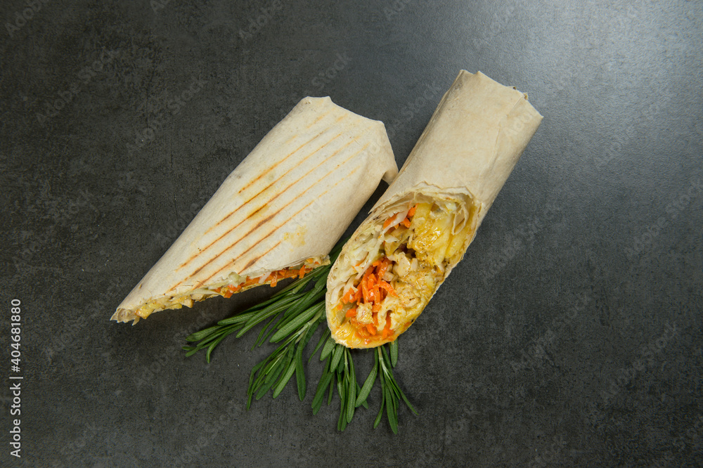 Top view Chicken meat shawarma served with fresh rosemary on dark stone ...