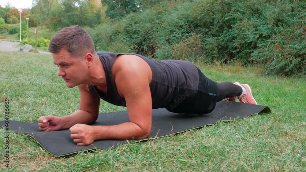 Fitness man doing plank exercise outdoor. Male athlete doing plank ...