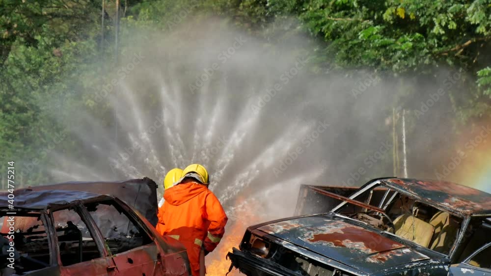 Firefighter fighting with flame using fire hose chemical water foam ...