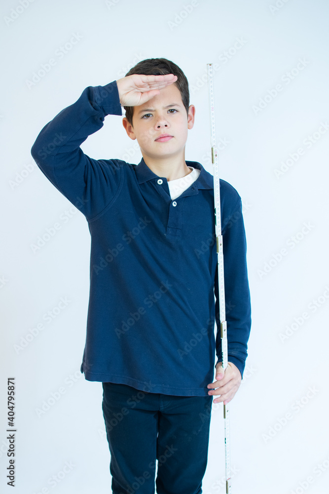Foto de Young Boy Holding a Meter Stick with One Arm is Stretching ...