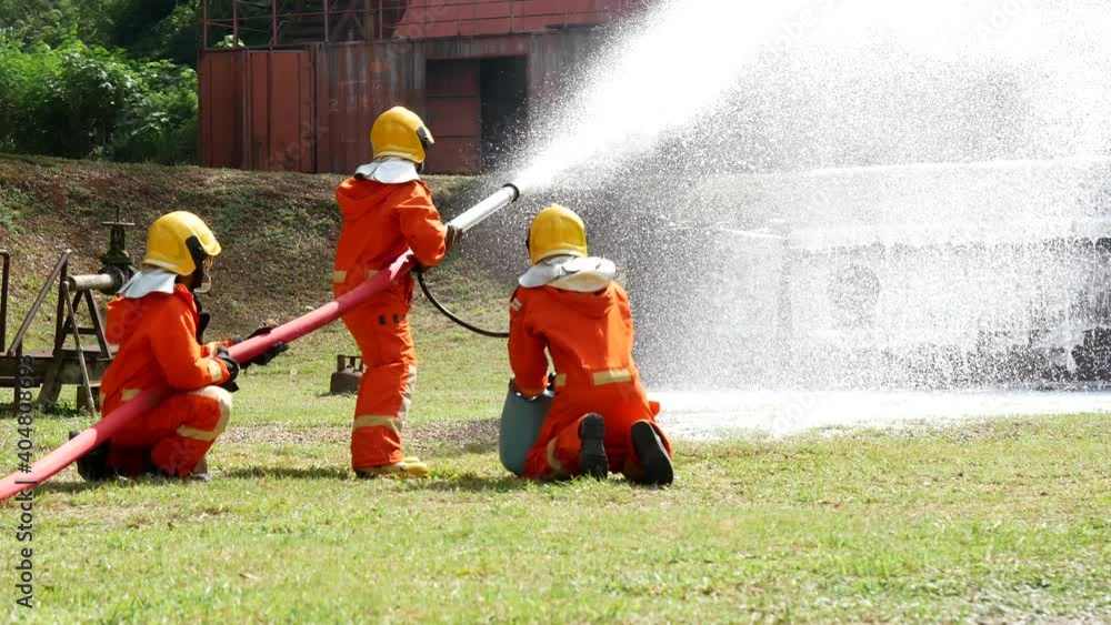 Firefighter fighting with fire flame protection property. Fireman wear ...