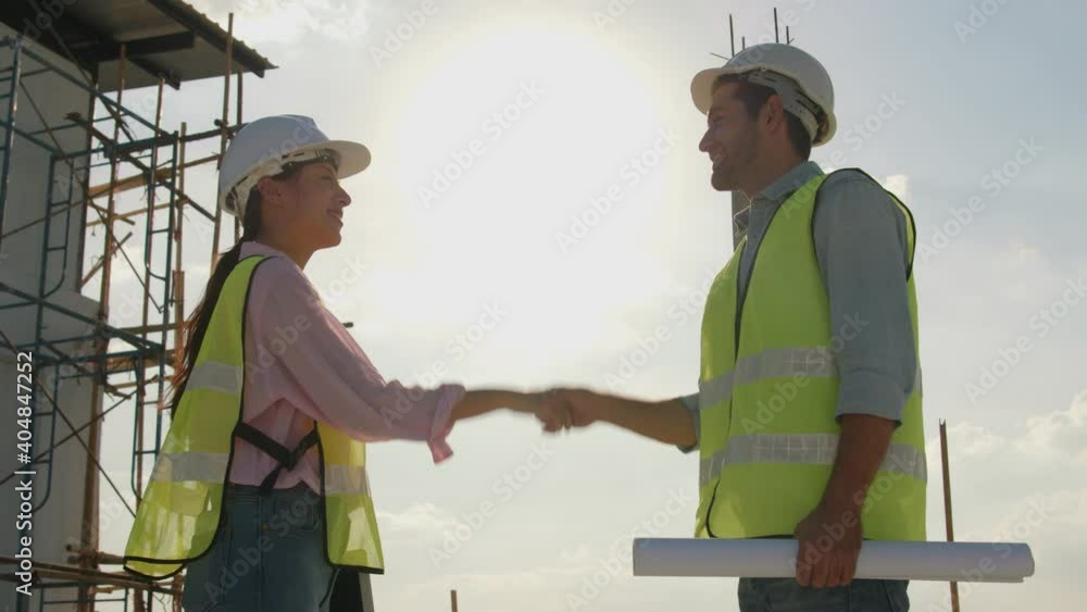 Successful team and professional engineer do handshake after working ...