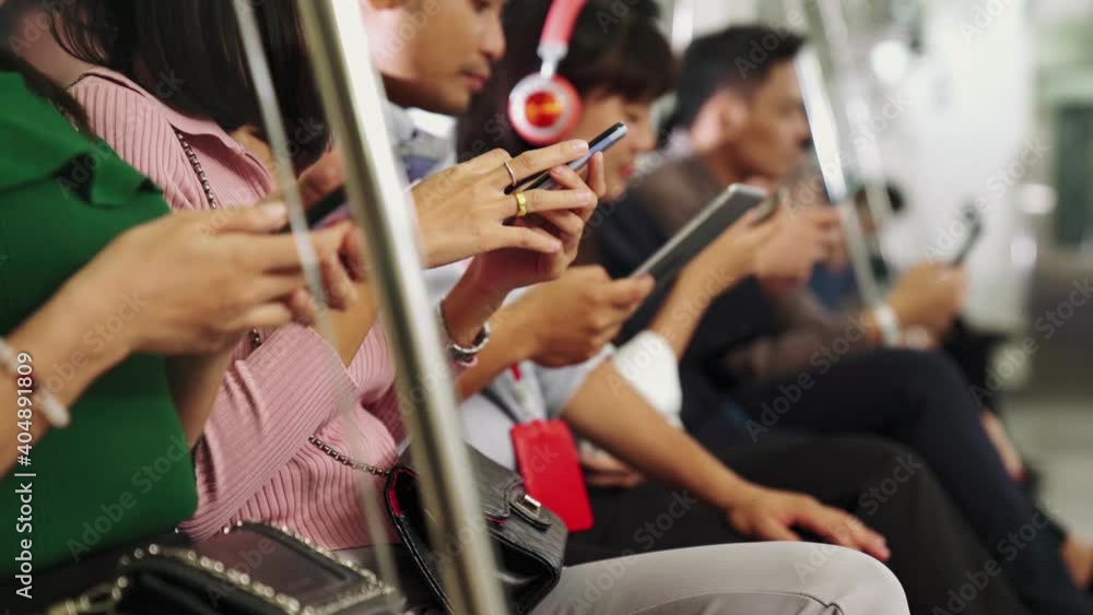 Young people using mobile phone in public underground train . Urban ...