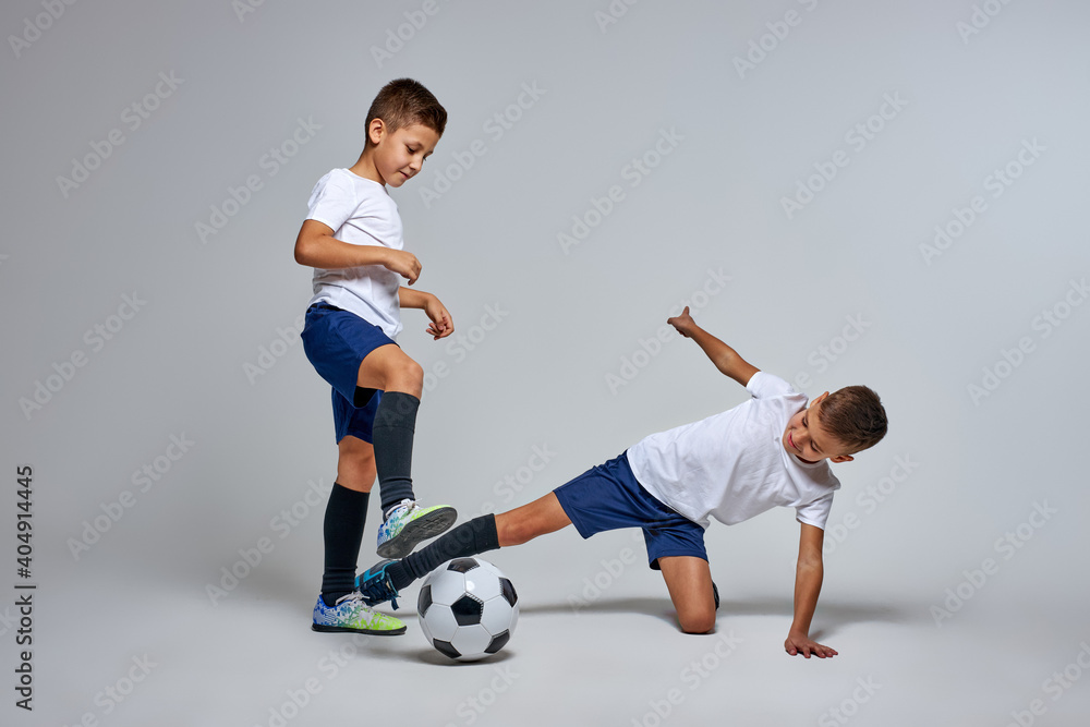kids playing soccer game, studio portrait of caucasian soccer players ...