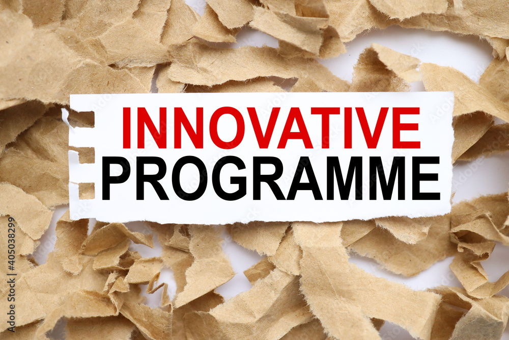 INNOVATIVE PROGRAM. text on white paper on torn paper background Stock ...