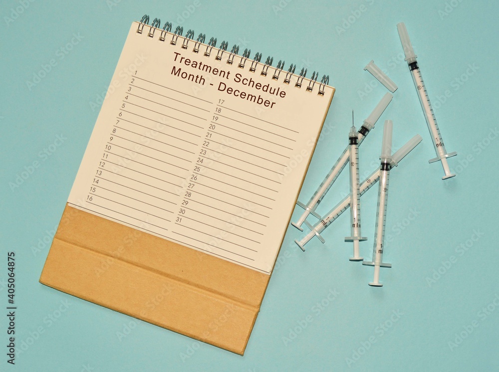 December treatment schedule calendar and disposable injection syringe ...