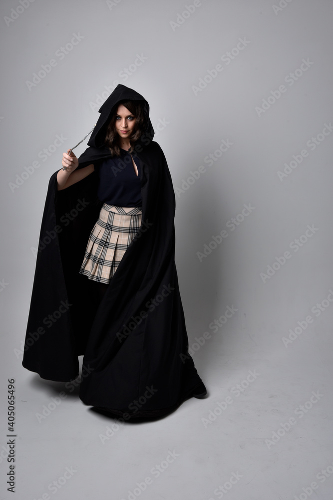 full length portrait of pretty brunette woman wearing tartan skirt and boots with long black ...