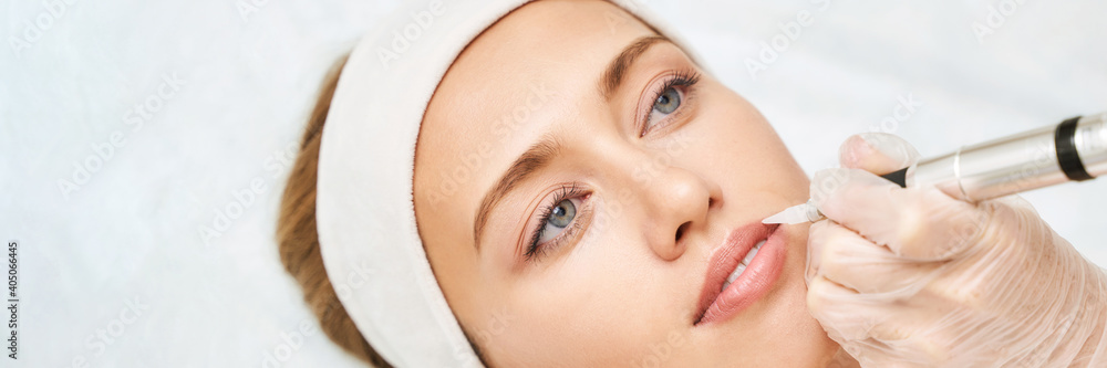 Permanent makeup. Beauty spa procedure. young woman. Face tattoo. Lip ...