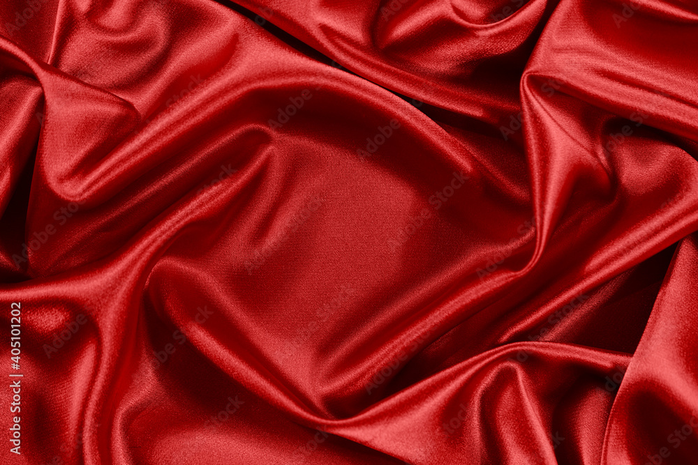 Red silk satin background. Shiny fabric with wavy soft pleats. Beautiful fabric background with ...