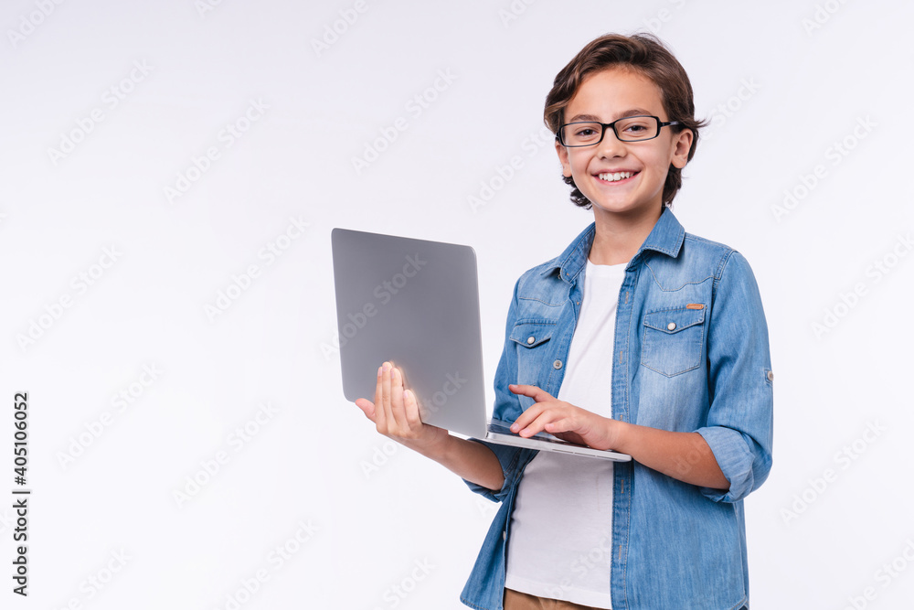 Smart little boy with laptop in casual clothes isolated over white ...