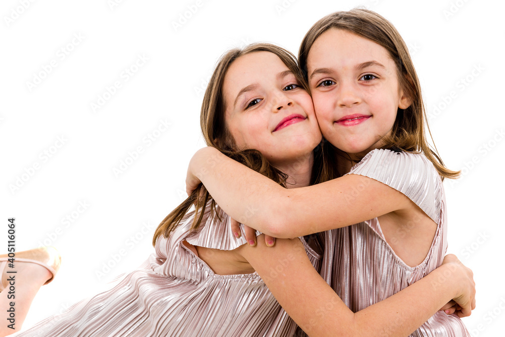 Identical twin girls sisters are posing for the camera. Stock Photo ...