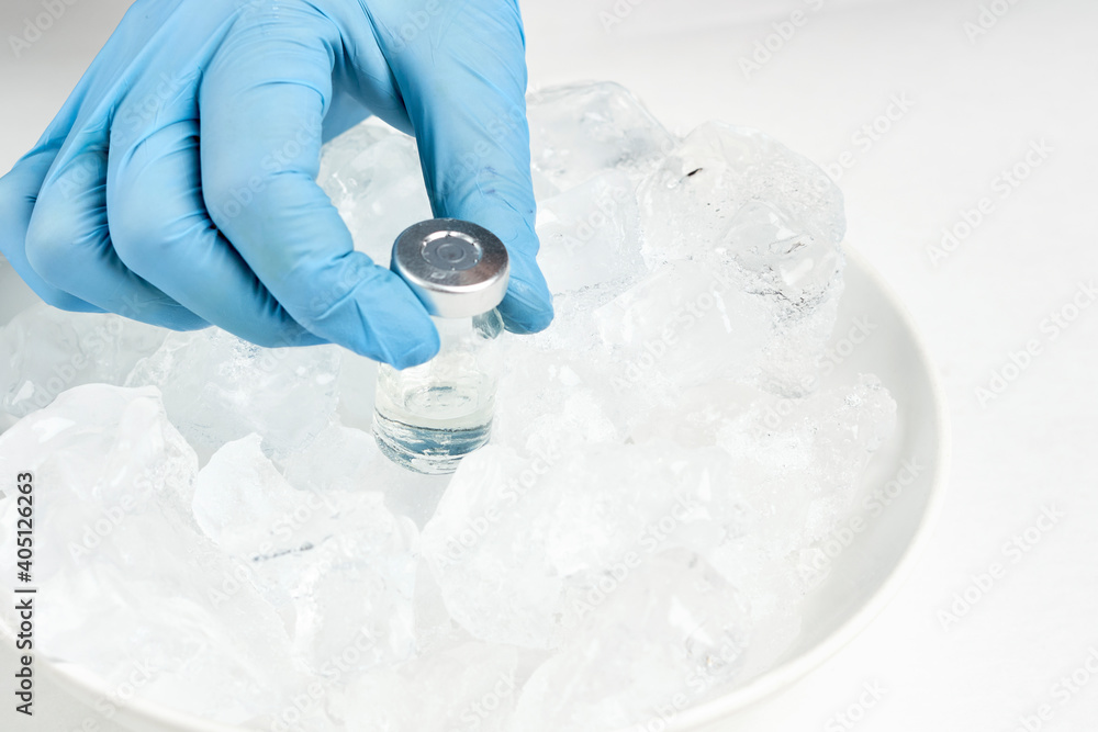 A doctor taking a vaccine vial from cold refrigerator and prepare ...