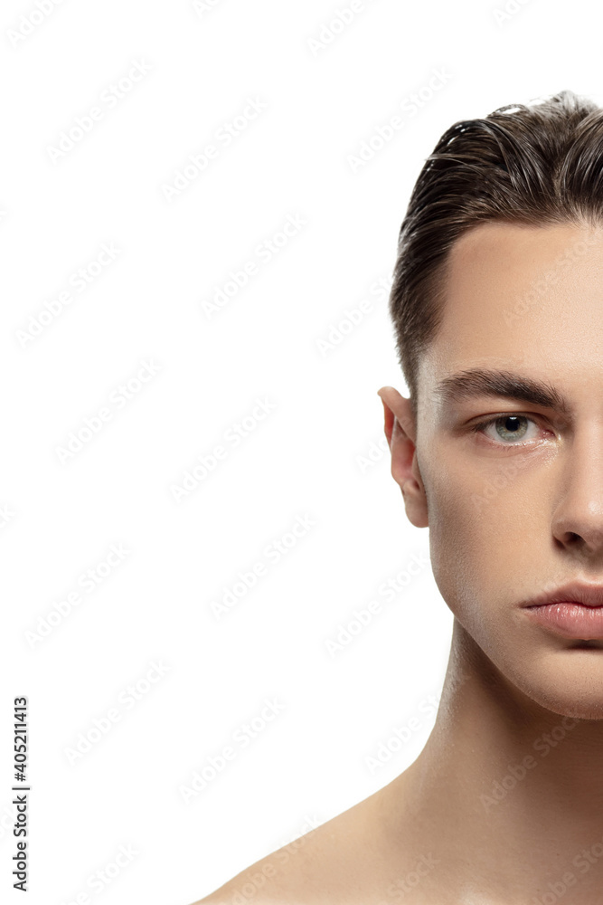 Half-face. Portrait of young man isolated on white studio background ...
