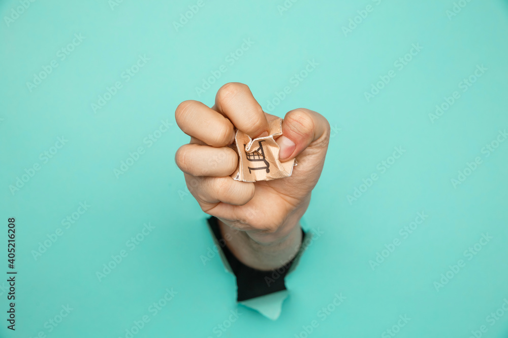 Hand with a broken delivery box through a blue paper hole. Shipment's ...