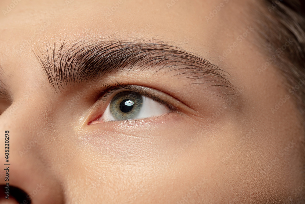 Eye dreamful. Close up face of young man on white studio background ...