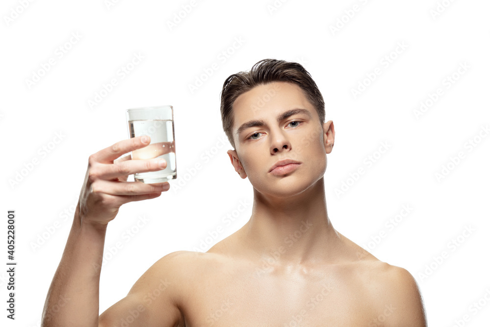 Pure water. Portrait of young man isolated on white studio background ...