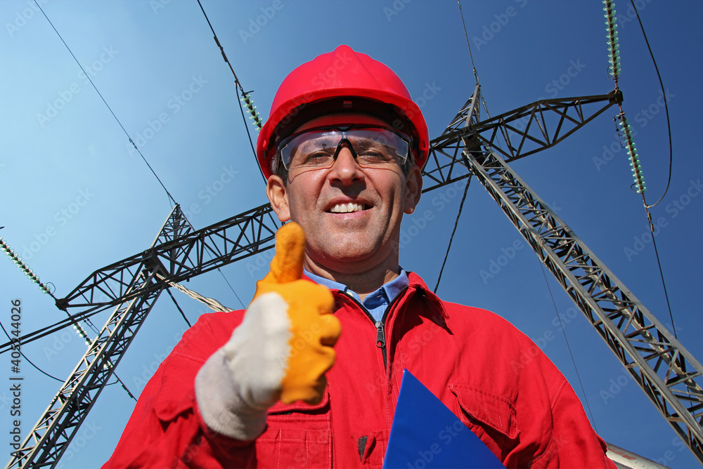 Electric Utility Worker Giving Thumbs Up Next to Electrical ...
