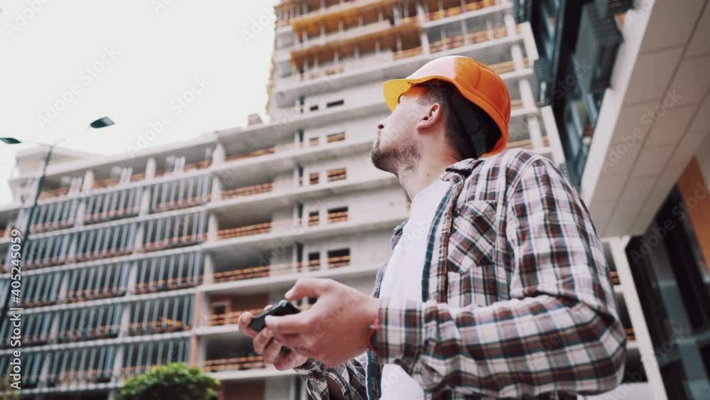 Architect working with smartphone on construction site. Engineer check ...