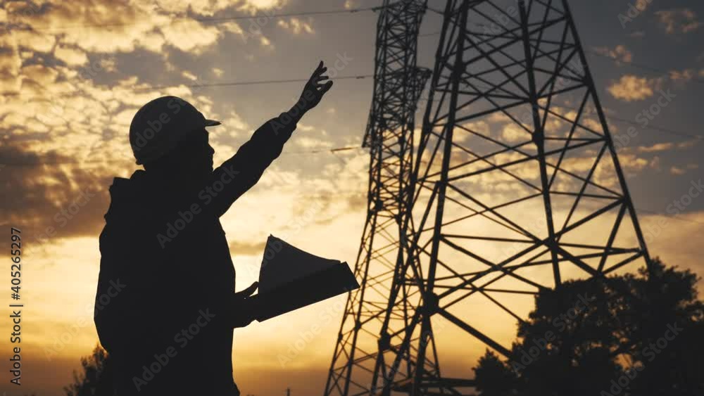 silhouette of an electrician engineer working next to an electrical ...