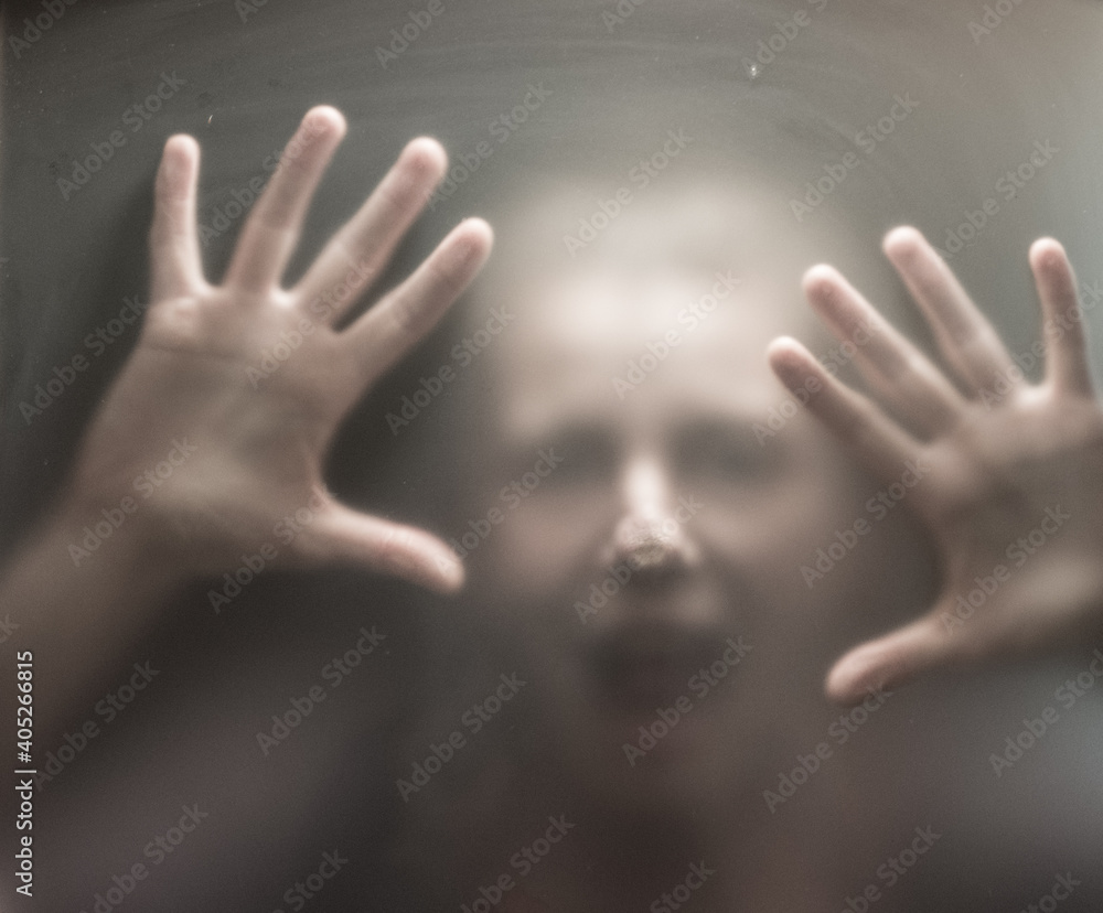Scary picture of hands behind glass. Stock Photo | Adobe Stock