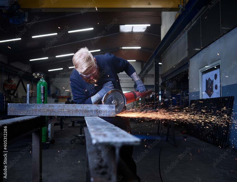 Manual worker using cutting material using circular grinder while ...