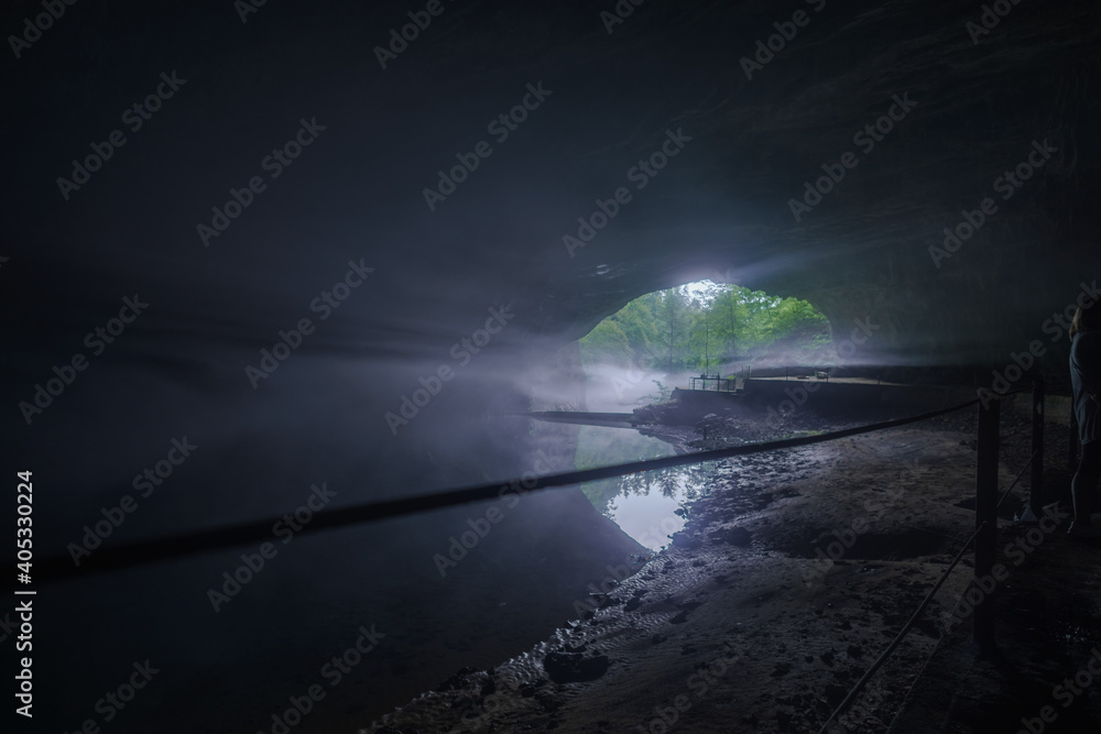 exit of an dark cave with underground river and some fog Stock Photo ...