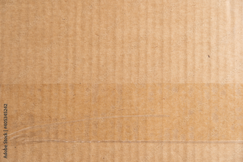 Brown cardboard texture with a transparent adhesive tape strip and some ...
