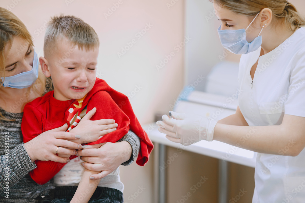 Little child medical visit. Doctor giving a child injection in arm ...