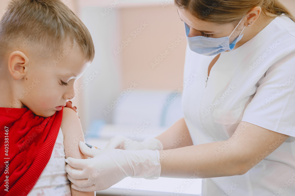 Little child medical visit. Doctor giving a child injection in arm ...