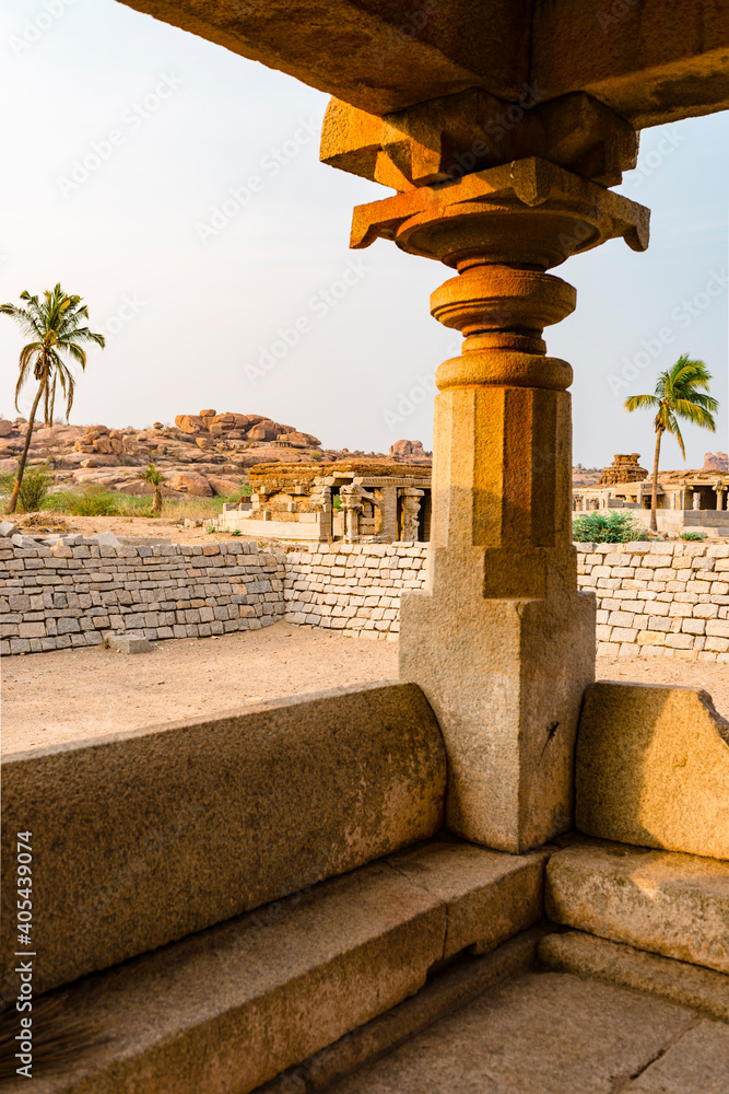 Granite Temple complex in ruins surrounded by palmtrees in desert ...