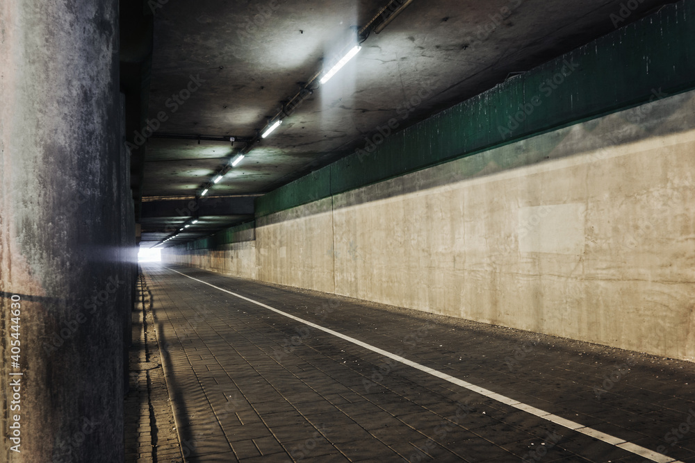 Horror tunnel background. Dark pavement tunnel with bright light at the ...