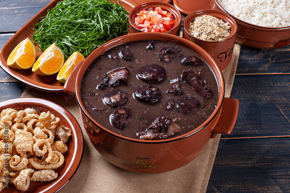 Typical Brazilian dish called Feijoada. Made with black beans, pork and ...