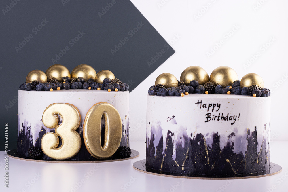 Festive black and white cakes 30 years old with golden balls and dark ...